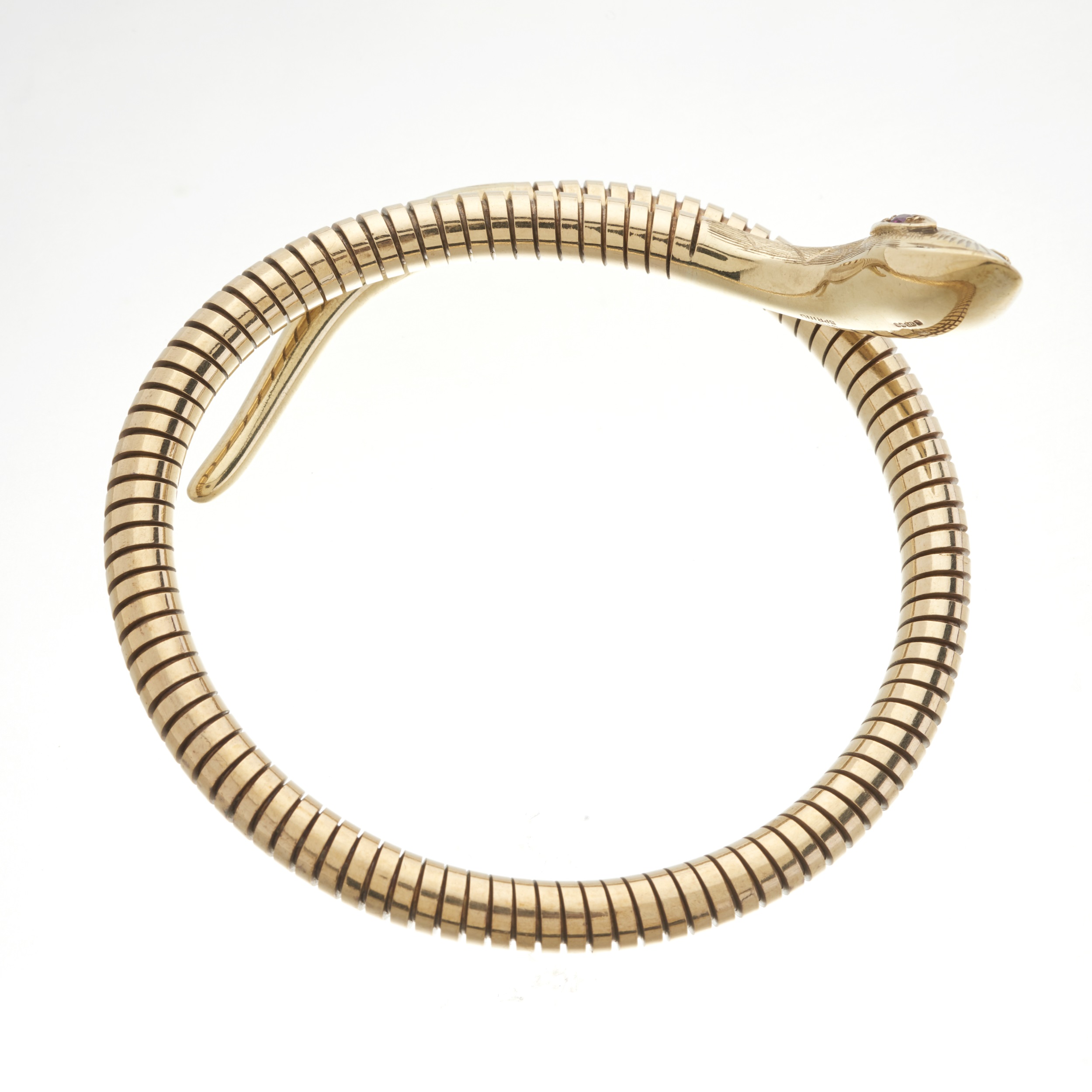 Lot 76 - A 9ct gold ruby snake bangle bracelet