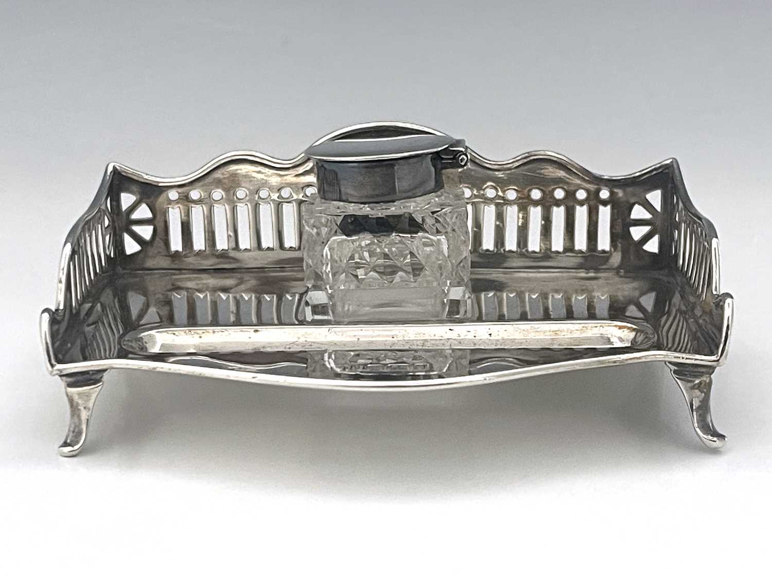 Lot 121 - An Edwardian silver inkstand, of shaped