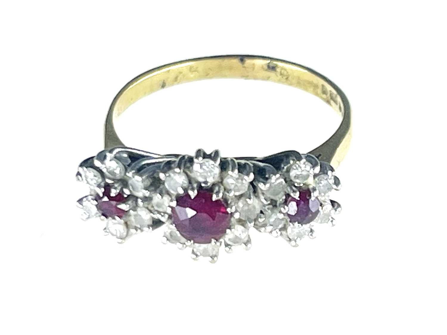 Lot 245 - An 18 carat gold ruby cluster ring, three