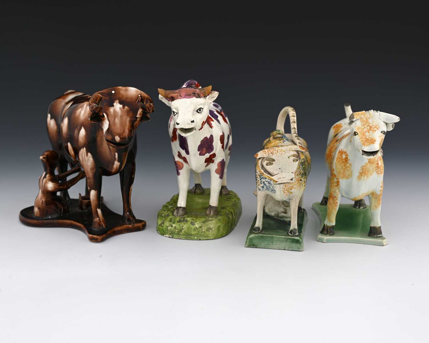 Lot 746 - Four 19th century pottery cow creamers,