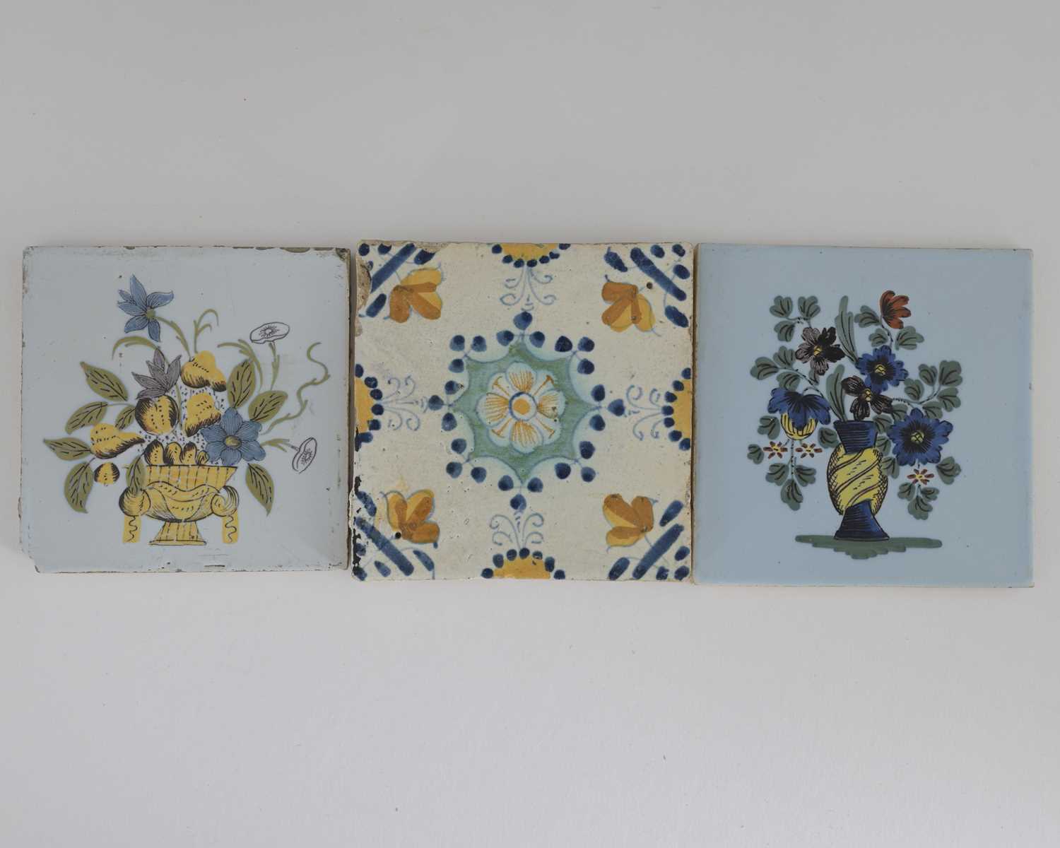 Lot 605 - Two English Delft polychrome floral tiles,